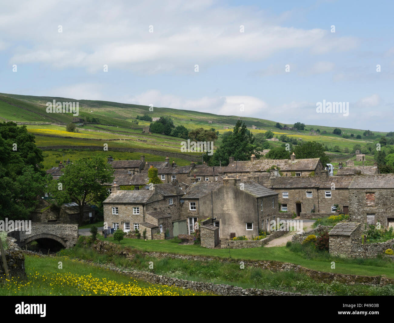 Looking down on small pretty unspoilt village of Thwaite in Swaledale ...