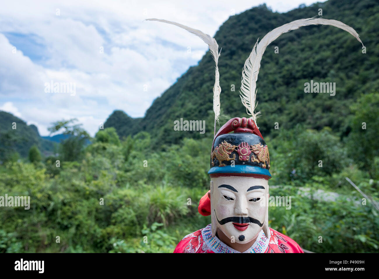 Performer wearing wooden mask for Buyi opera, Buyi ethnic minority ...