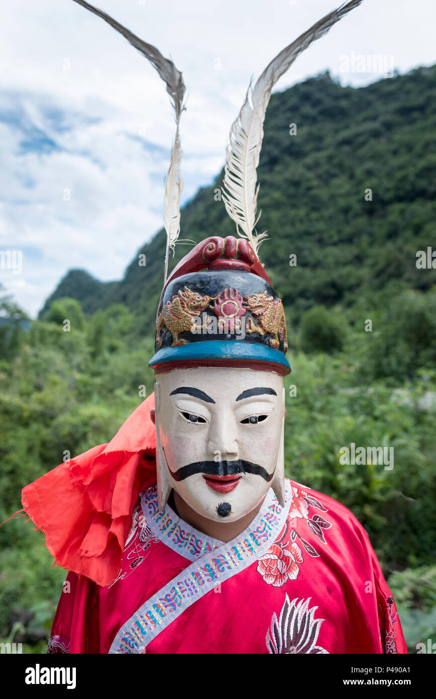 Performer wearing wooden mask for Buyi opera, Buyi ethnic minority ...