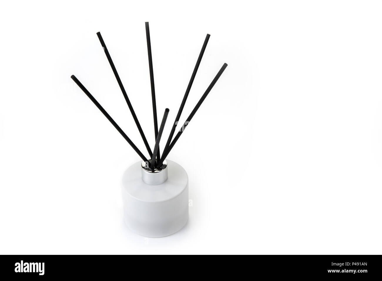 Scent sticks in the glass on the white background Stock Photo - Alamy