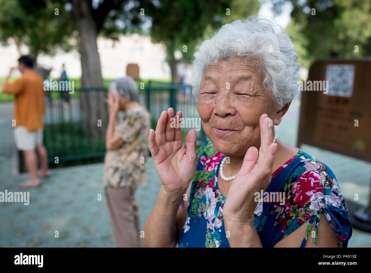 Retirees do face exercises in park surrounding the Temple Of Heaven ...