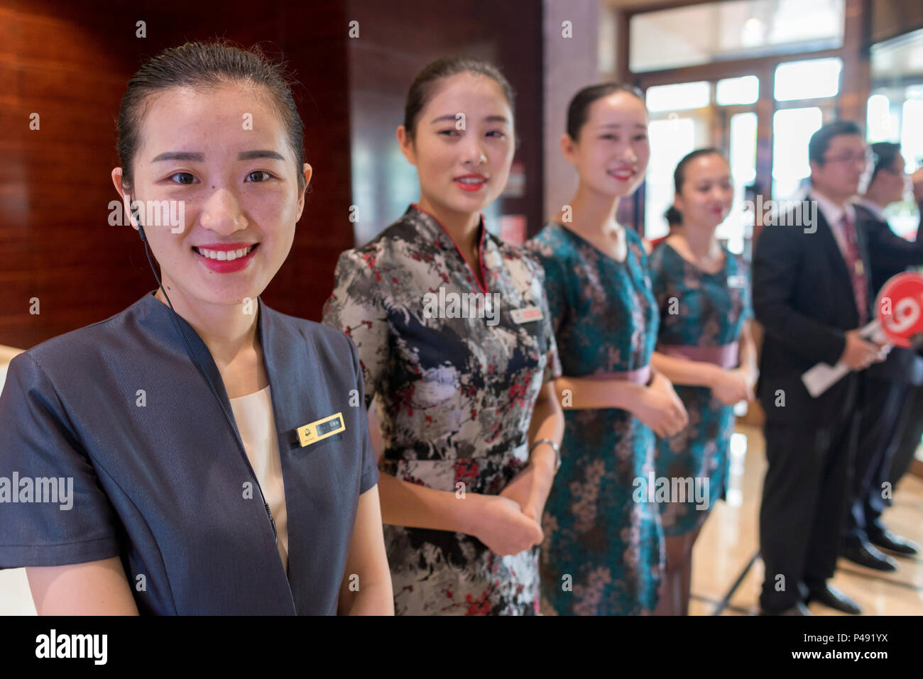 Luxury hotel staff greet foreign visitors in lobby, Beijing, China ...
