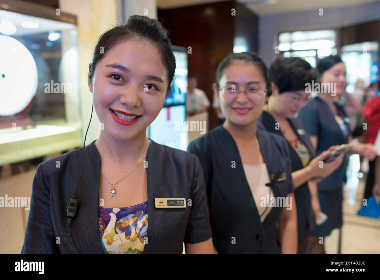 Luxury hotel staff greet foreign visitors in lobby, Beijing, China ...