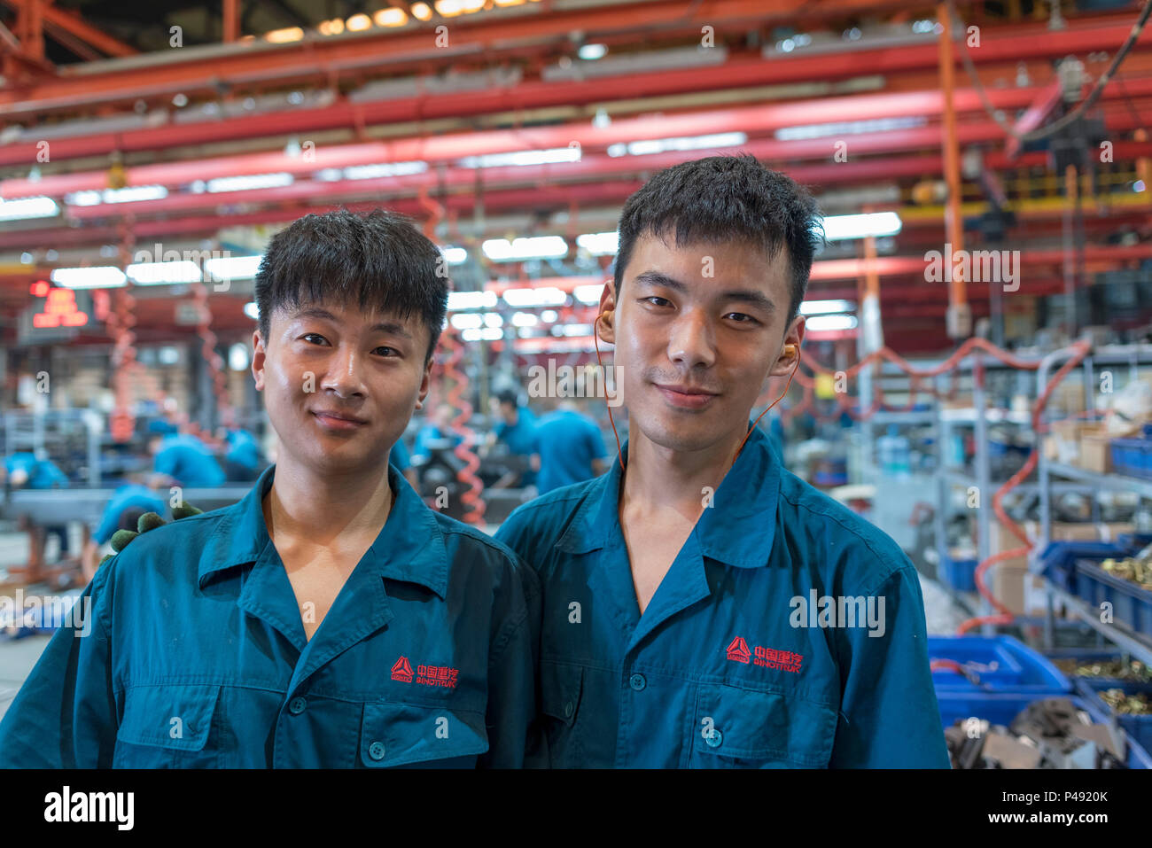 Assembly line workers at China National Heavy Duty Truck Group, Jinan ...