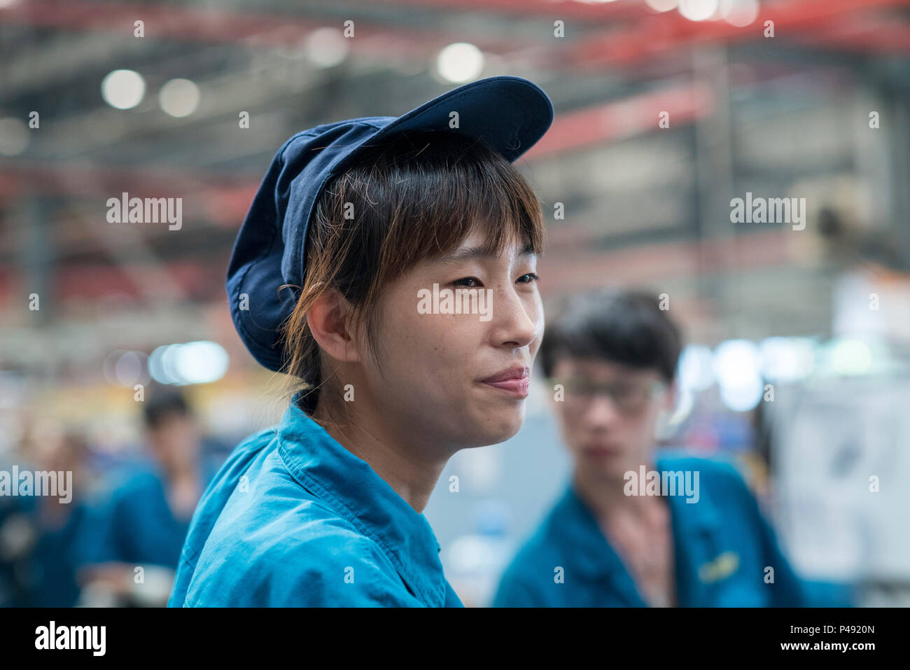Assembly line workers at China National Heavy Duty Truck Group, Jinan ...