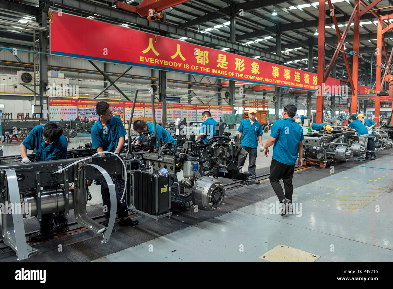 Assembly line workers at China National Heavy Duty Truck Group, Jinan ...