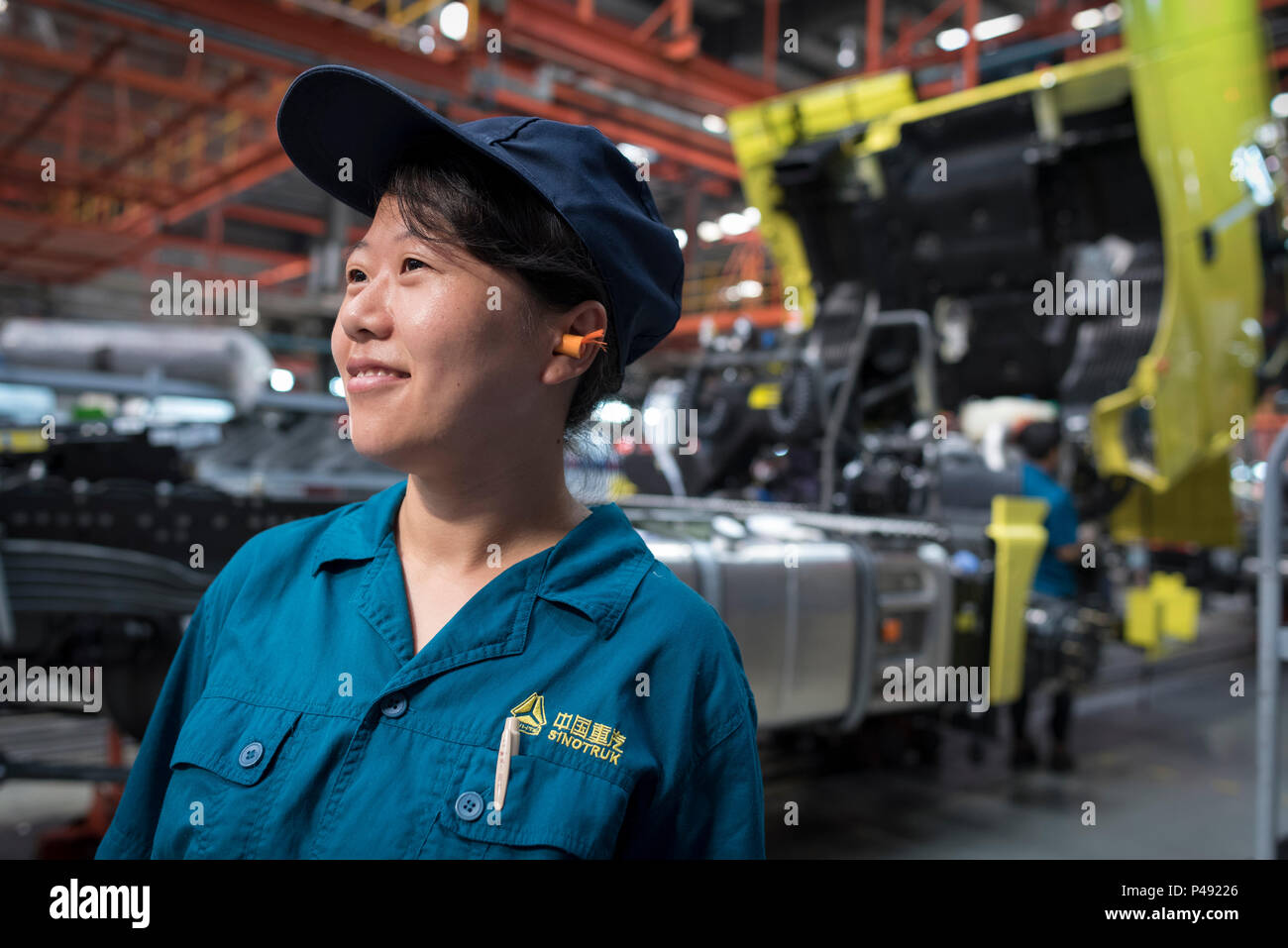 Assembly line workers at China National Heavy Duty Truck Group, Jinan ...