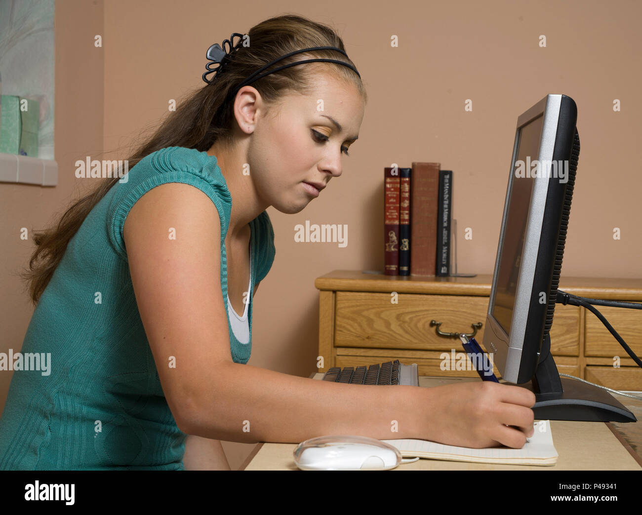 teen girl using computer to do homework. MR © Myrleen Pearson ...