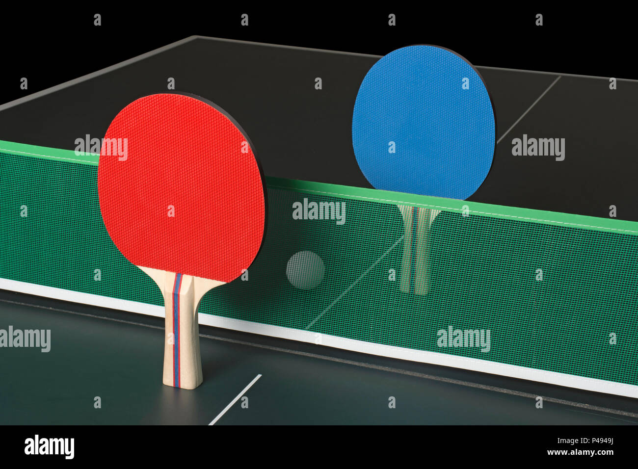 Ping Pong Paddles on Ping Pong Table, standing upright with net in ...