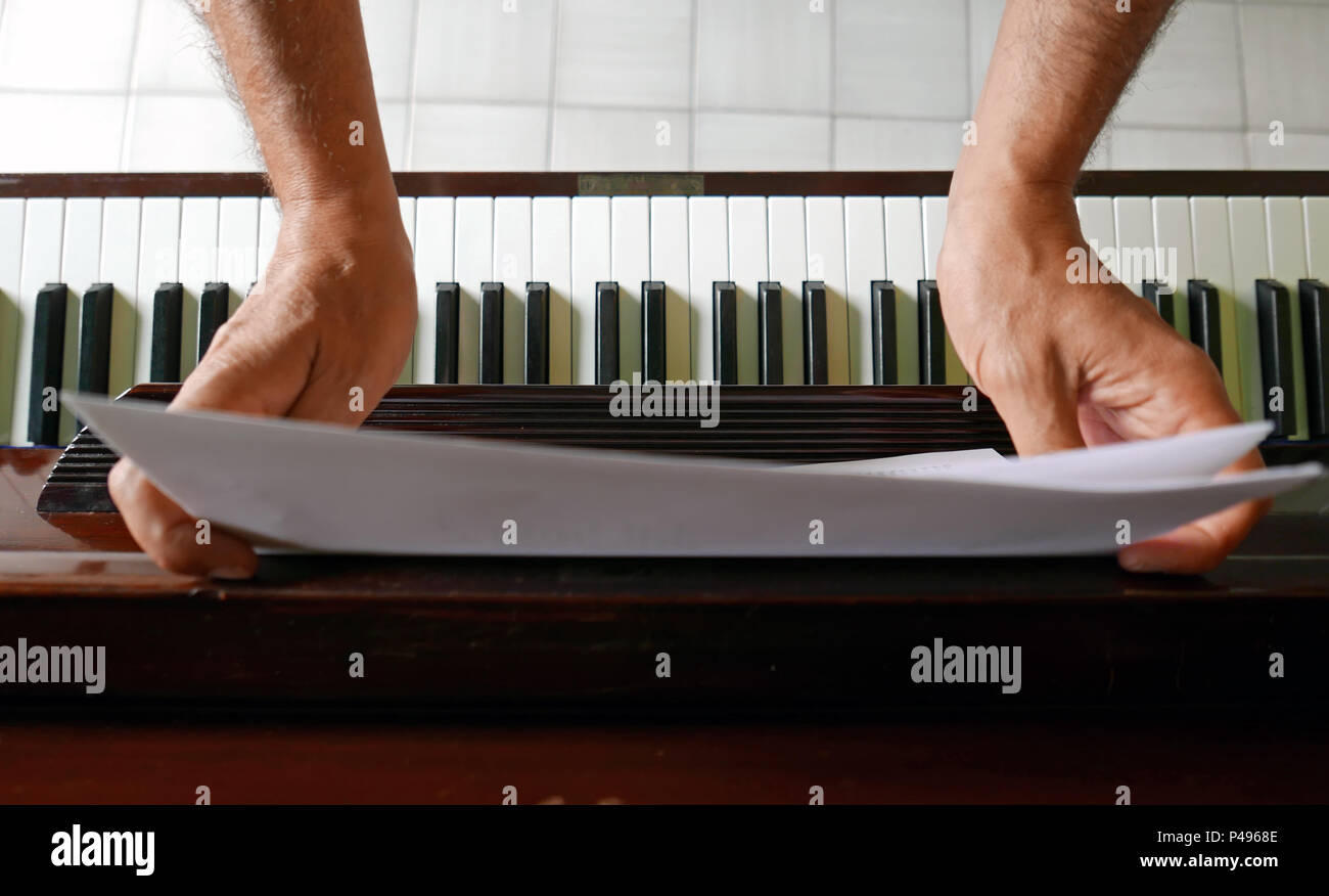 hands holding sheet music, piano art musical concept Stock Photo - Alamy