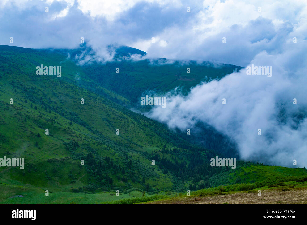 Mountain valley with clouds. Rainy day.Beautiful landscape Stock Photo ...