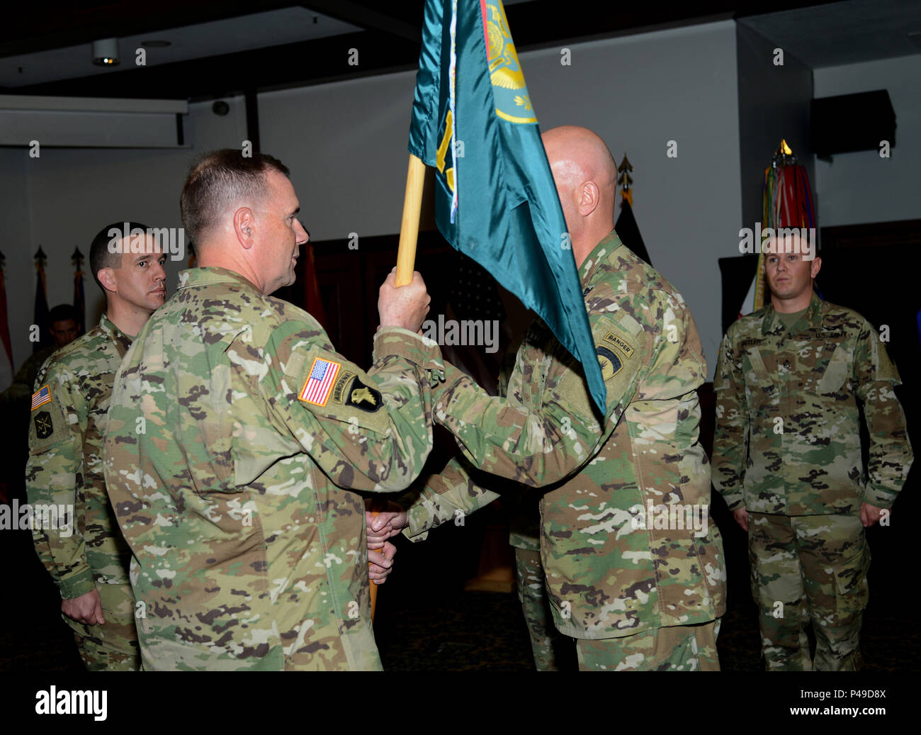 Col. Richard P. Ullian, outgoing commander, passes the Unit’s guidon to ...