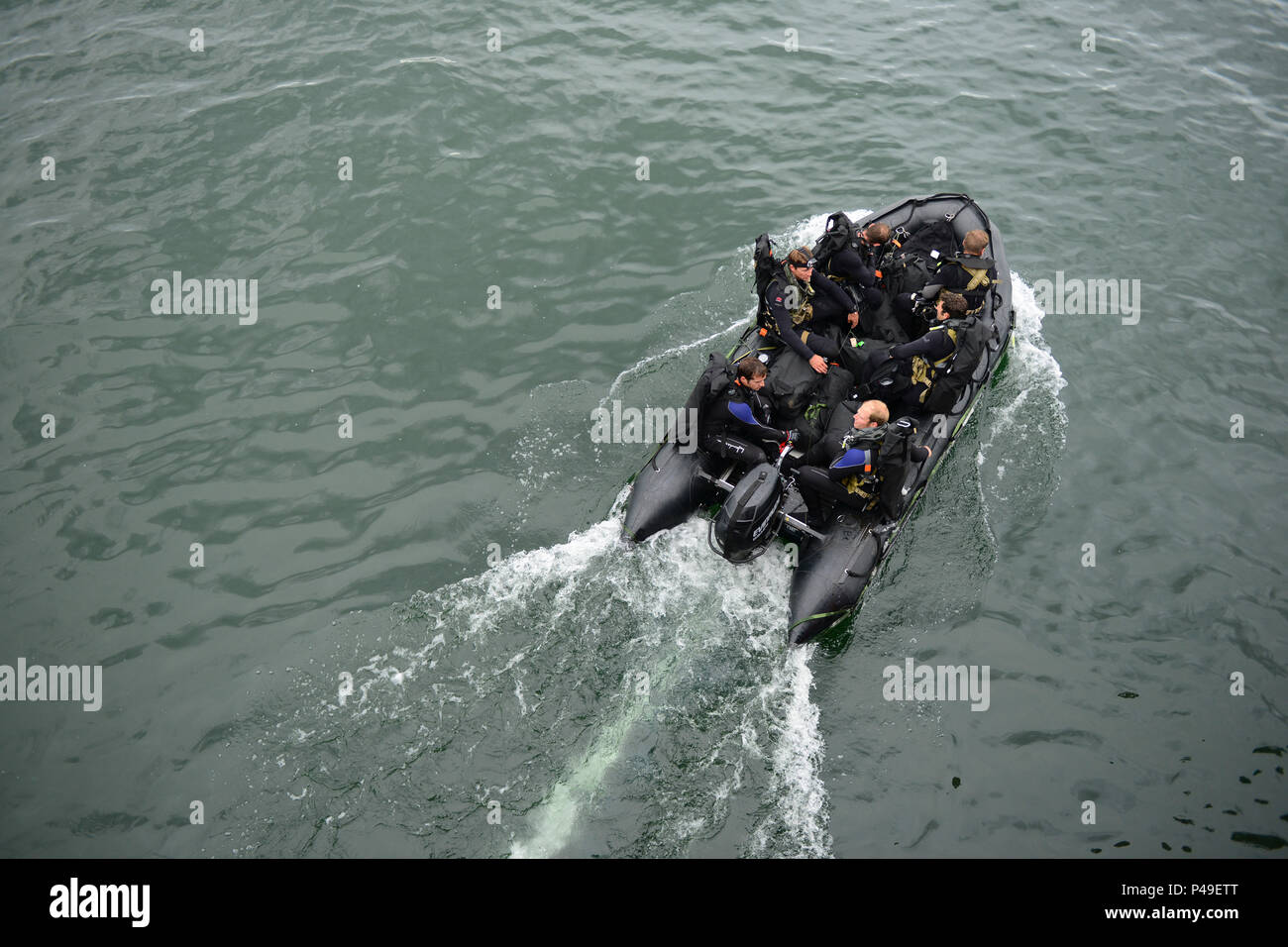 A Zodiac, rigid-hulled inflatable boat, filled with six members of a U ...