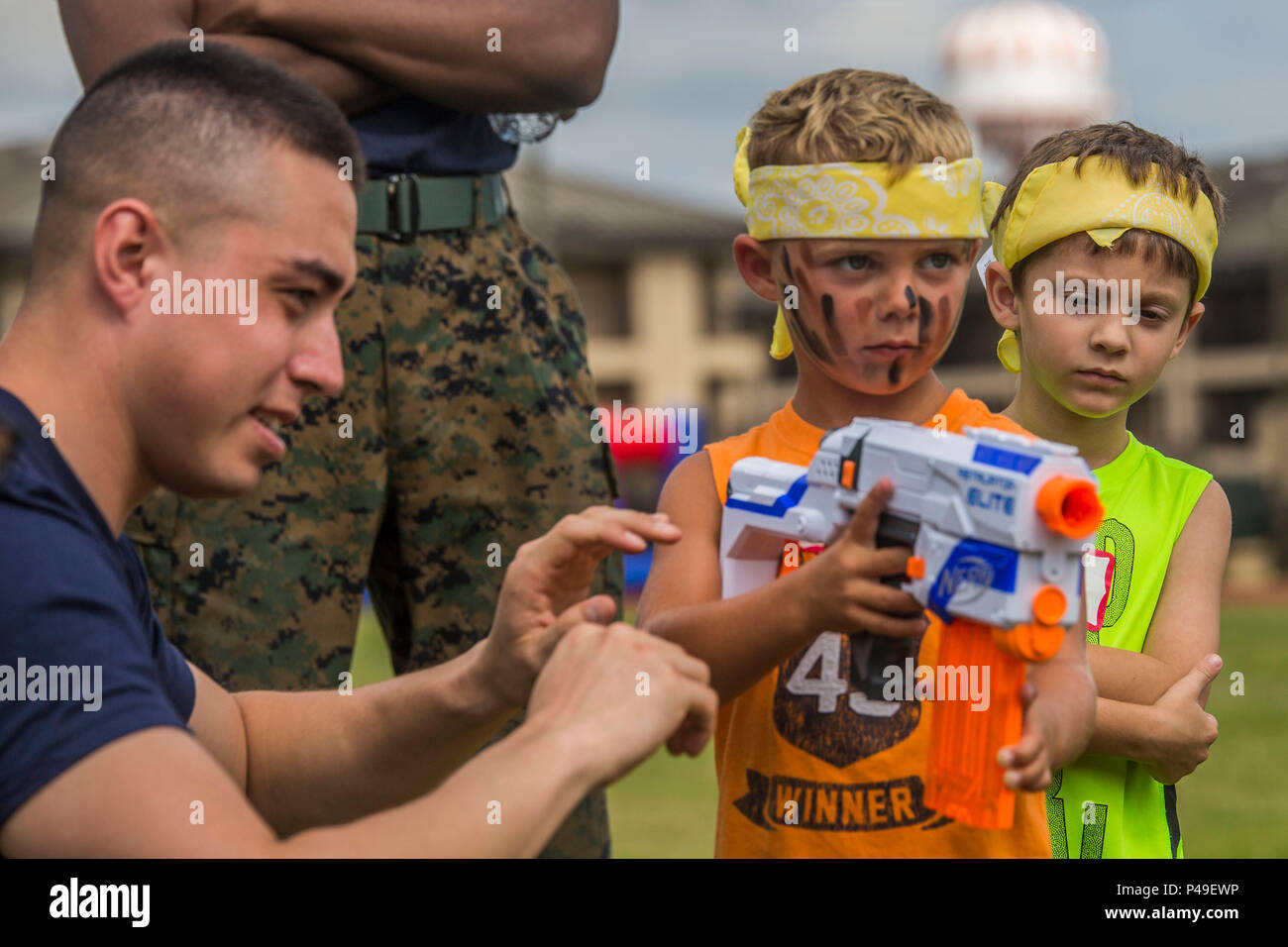 A child learns marksmanship during the Lifestyle, Insights, Networking ...