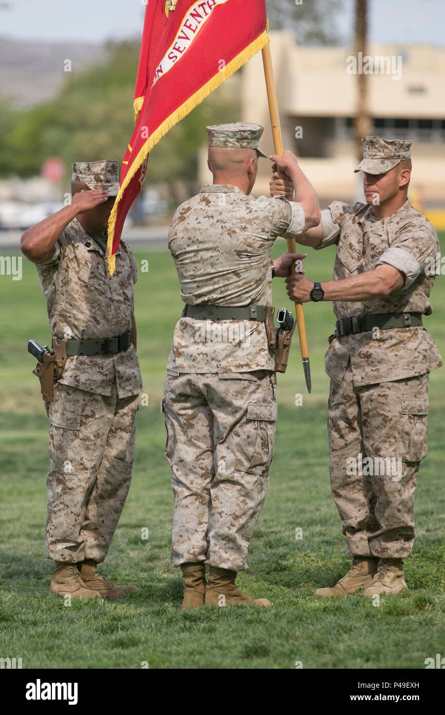 Lt. Col. David Hart, off-going commanding officer, ceremonially passes the 1st Battalion, 7th ...