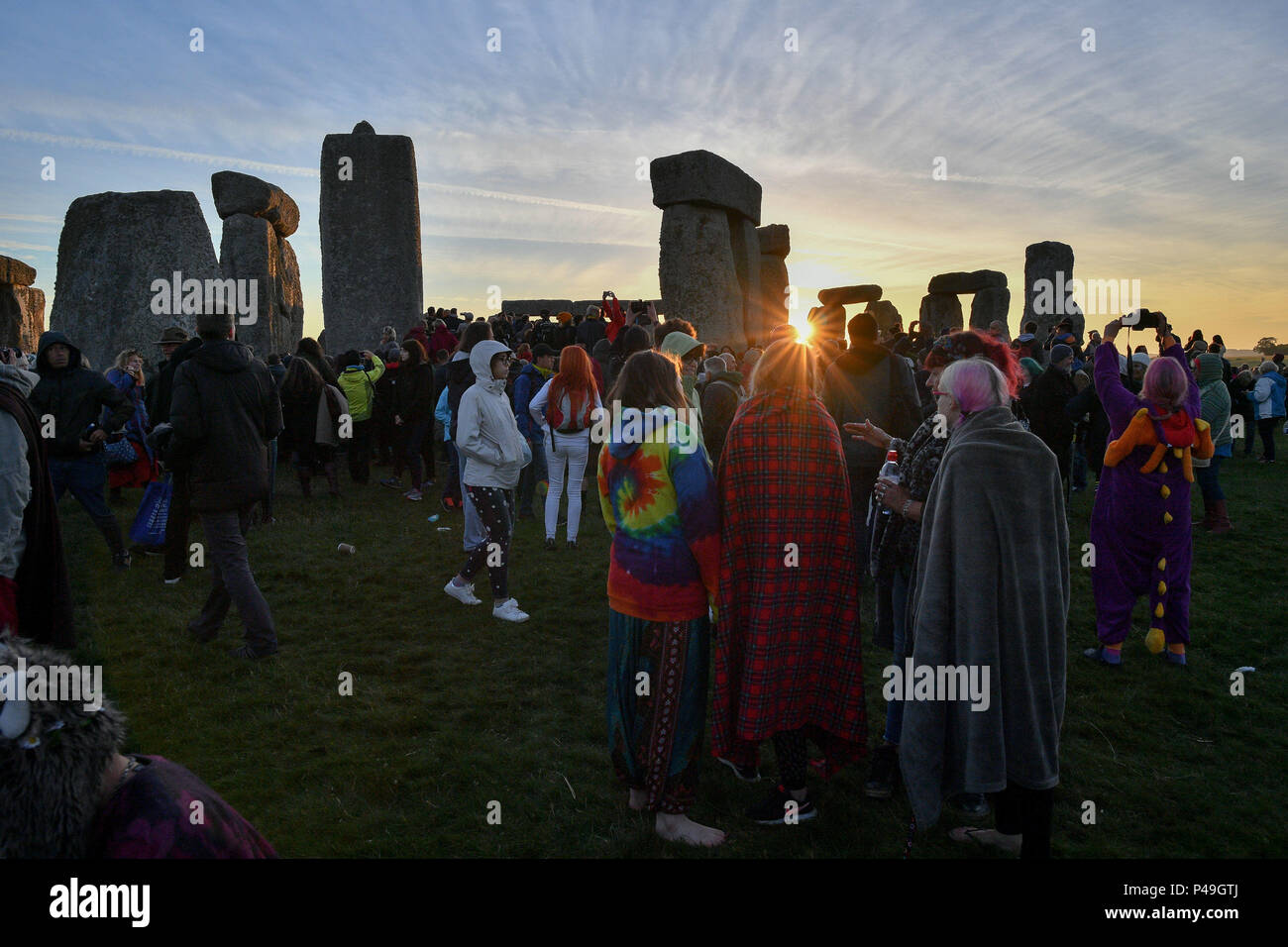 The sun breaks the horizon and shines through the stones at Stonehenge ...