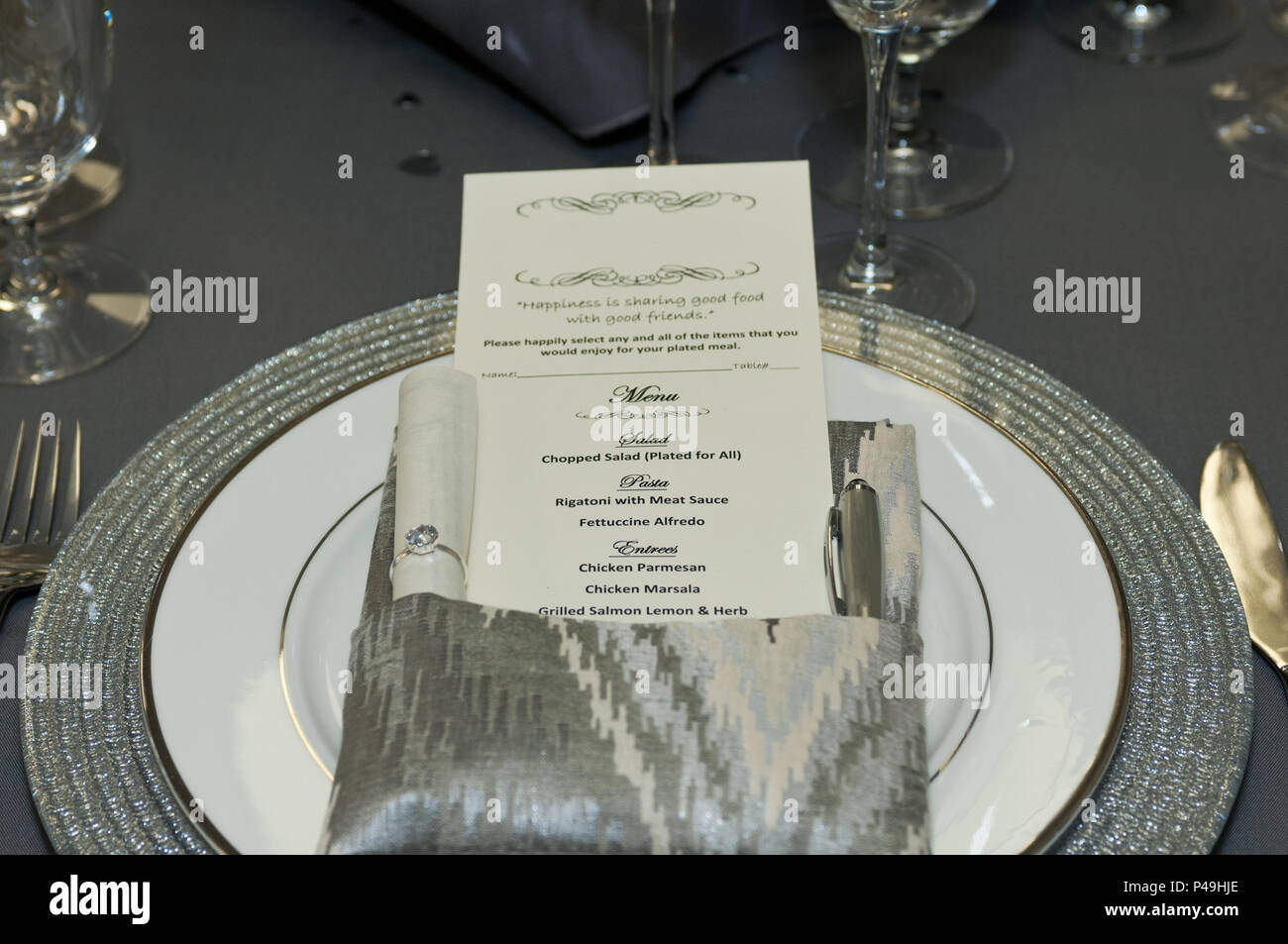 Beautiful and stylish wedding table set up with white and silver plates ...