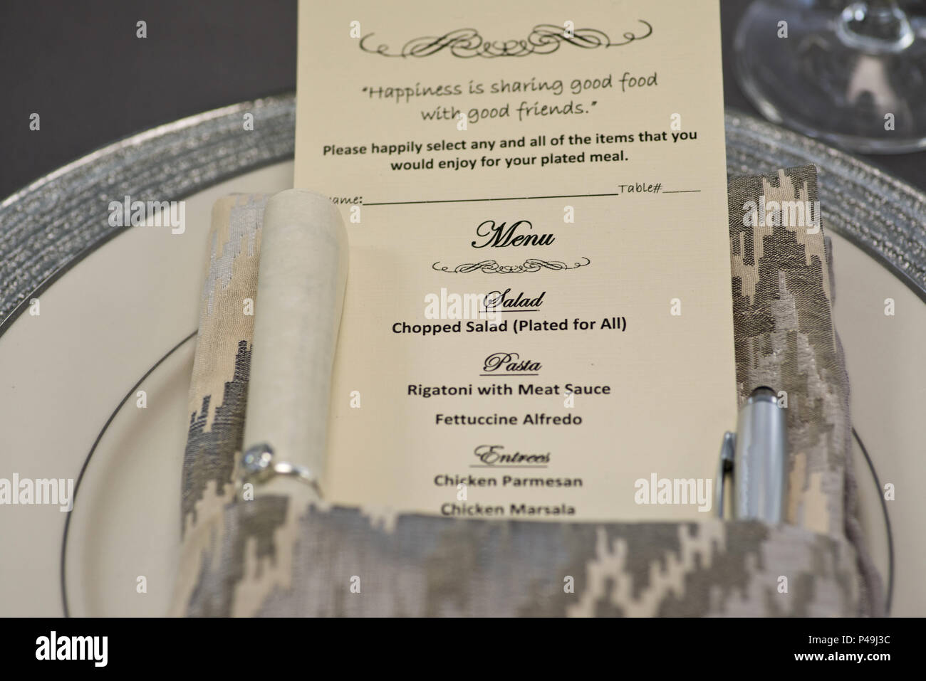 Beautiful and stylish wedding table set up with white and silver plates ...