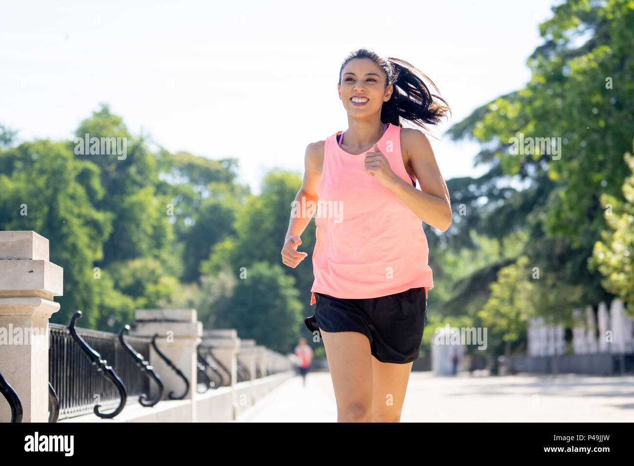 young attractive and happy runner woman in Autumn sportswear running ...
