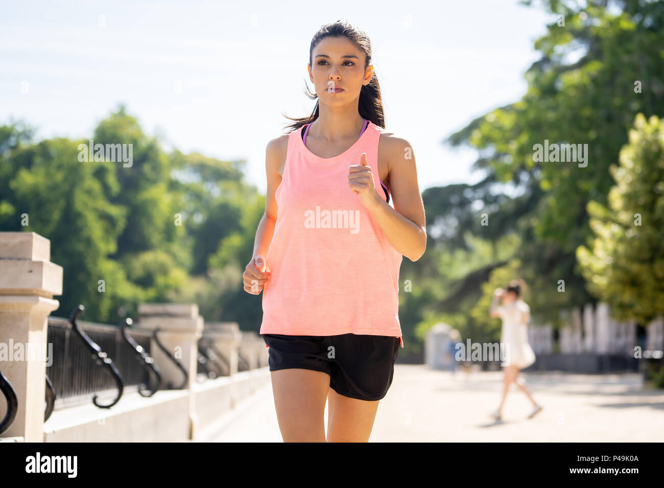 Running woman runner suffering from jogging in sunny bright light ...