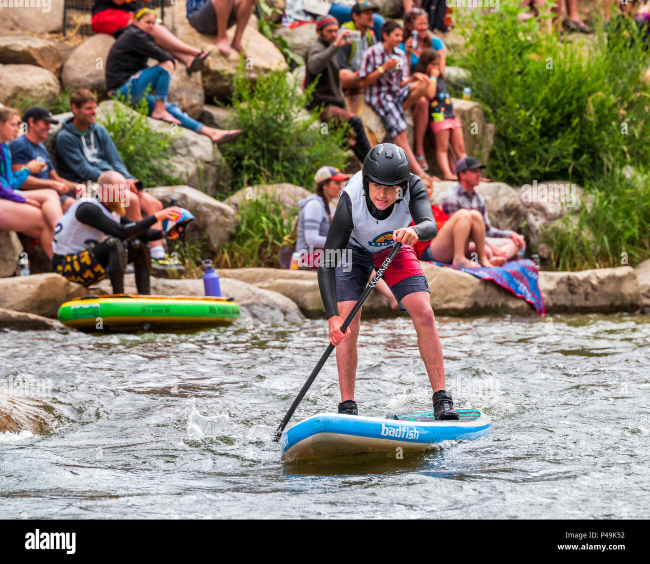 Female competitor races in standup paddleboard event; Fibark river ...