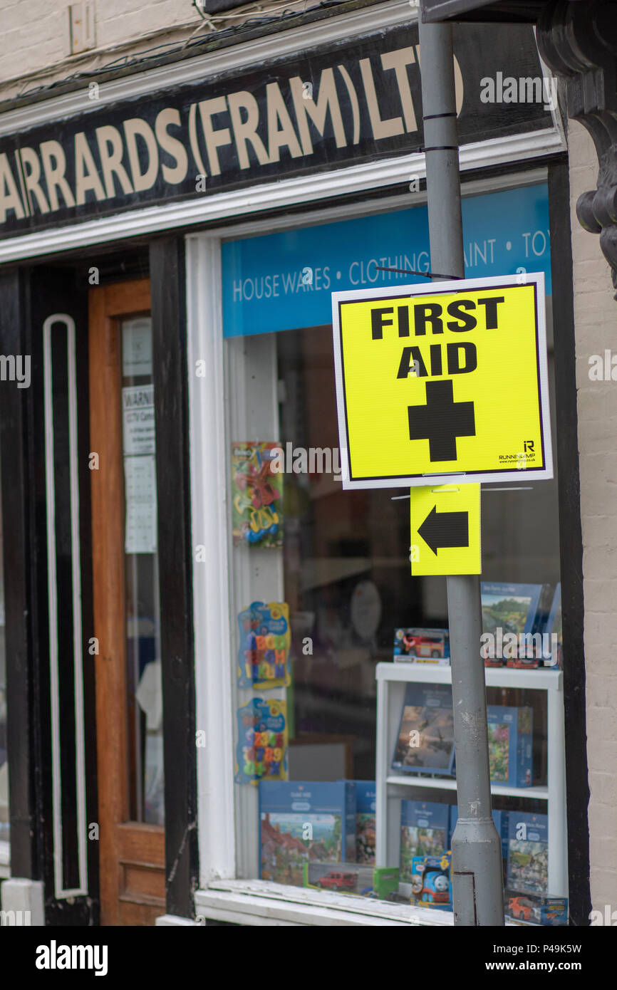 Bright yellow temporary first aid signs Stock Photo - Alamy