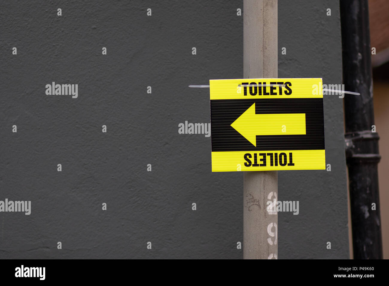 Temporary toilets direction arrow sign Stock Photo - Alamy