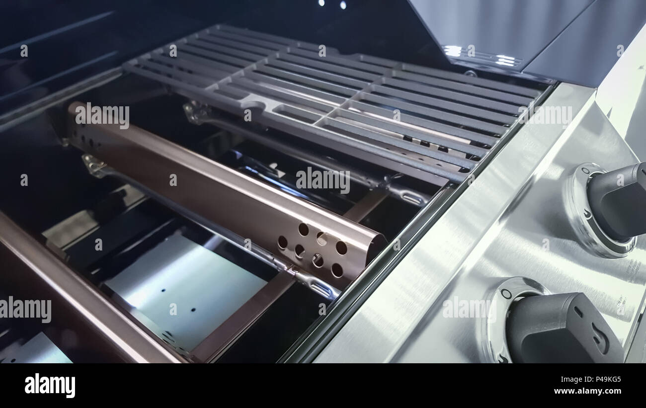 Closeup of Gas Barbecue Grill burners, flavorizer bars, porcelanized ...