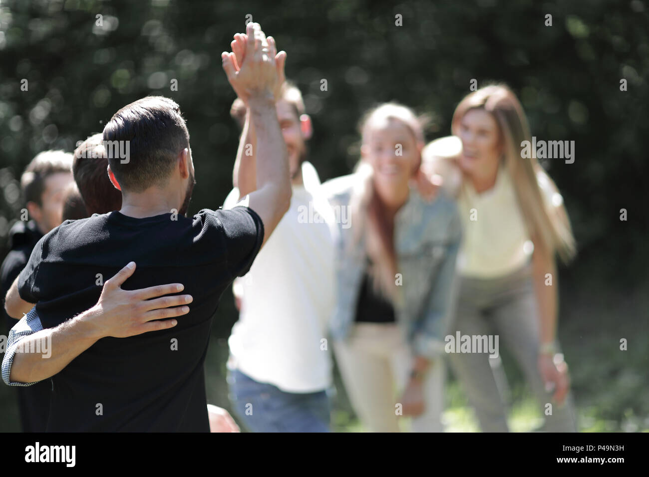 group of friends giving each other a high five Stock Photo - Alamy
