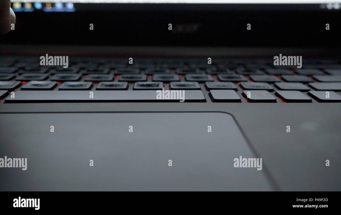 Close-up view fingers tapping keypad of laptop and writing message ...