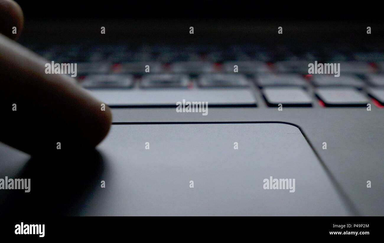 Close-up view fingers tapping keypad of laptop scrolling and stretching ...