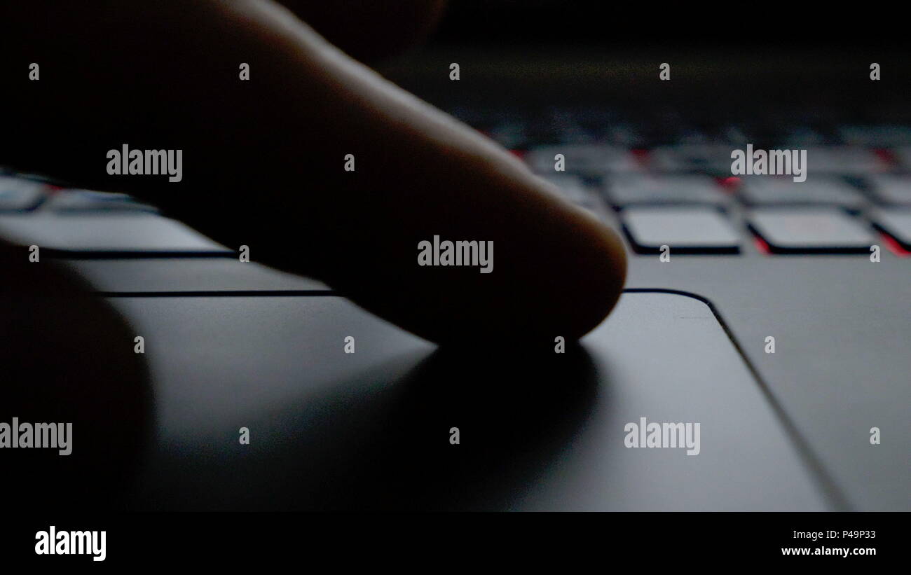 Close-up view fingers tapping keypad of laptop scrolling and stretching ...