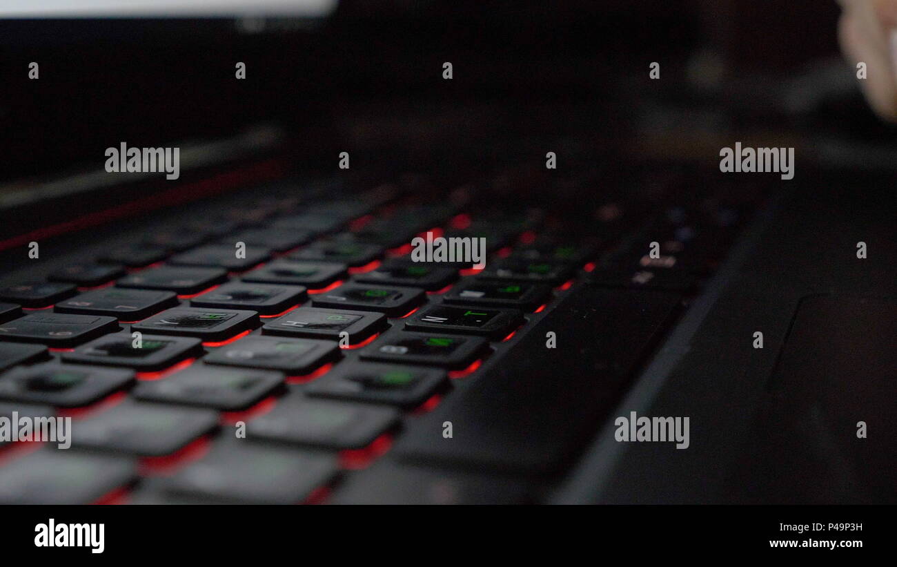 Close-up view fingers tapping keypad of laptop and writing message ...