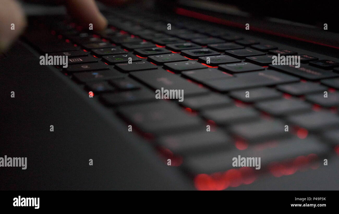 Close-up view fingers tapping keypad of laptop and writing message ...