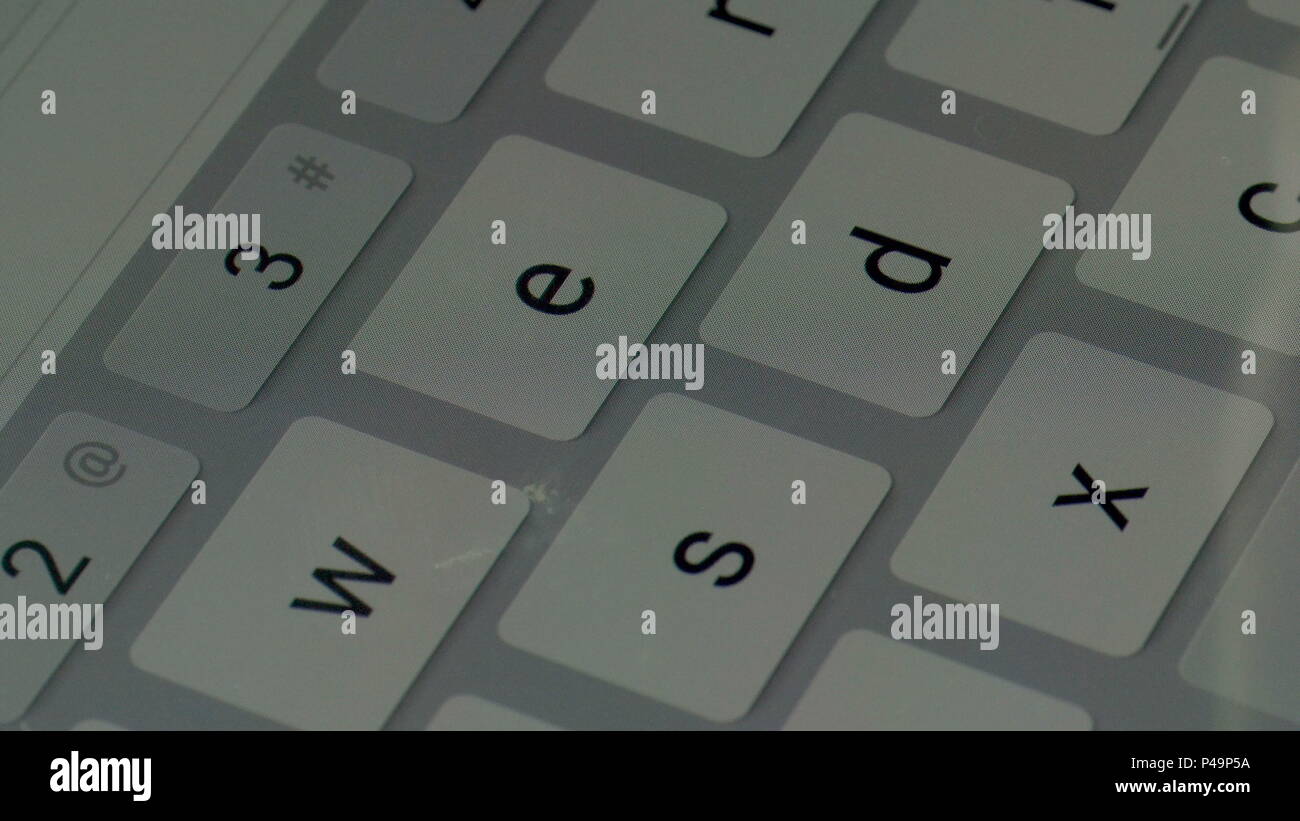 Close-up view fingers tapping keypad of tablet and writing message on ...
