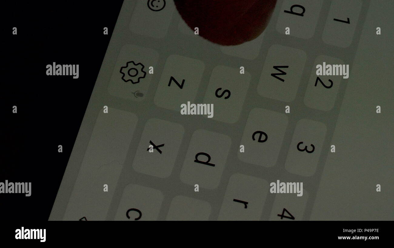 Close-up view fingers tapping keypad of smart phone and writing message ...