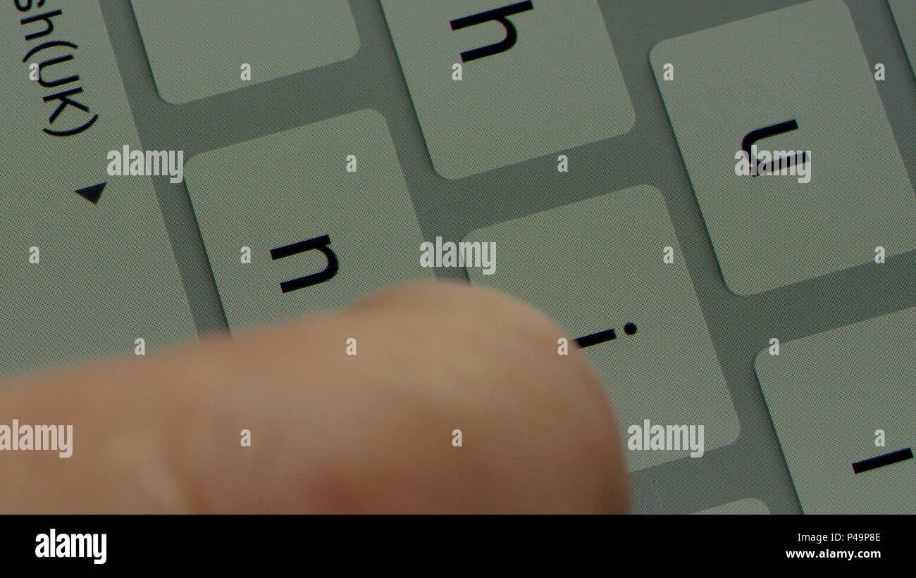 Close-up view fingers tapping keypad of tablet and writing message on ...