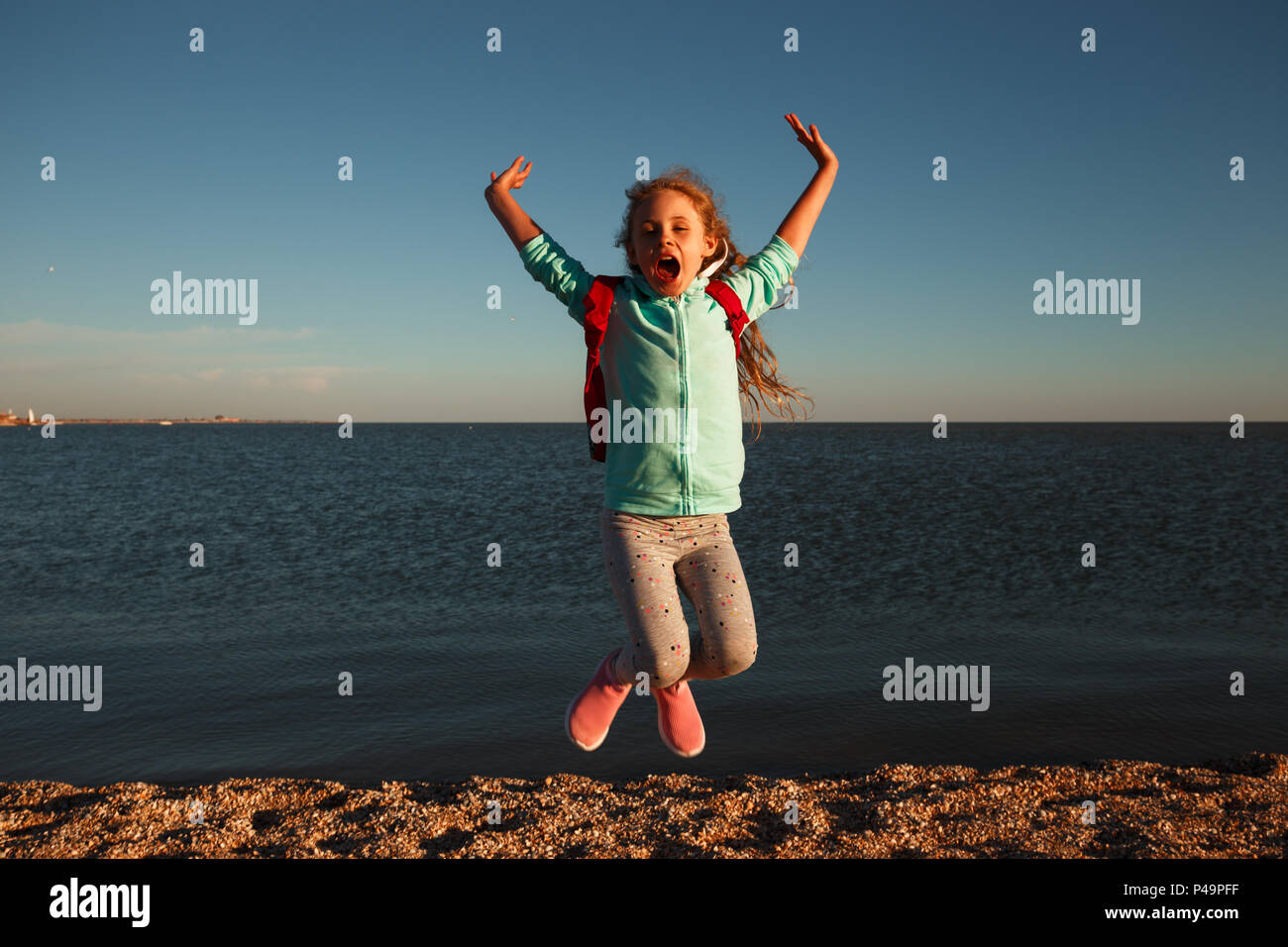 Kids jumping beach sunset hi-res stock photography and images - Alamy