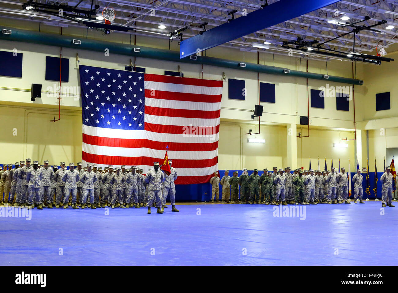 U.S. Marines and Sailors with 5th Marine Expeditionary Brigade stand in ...