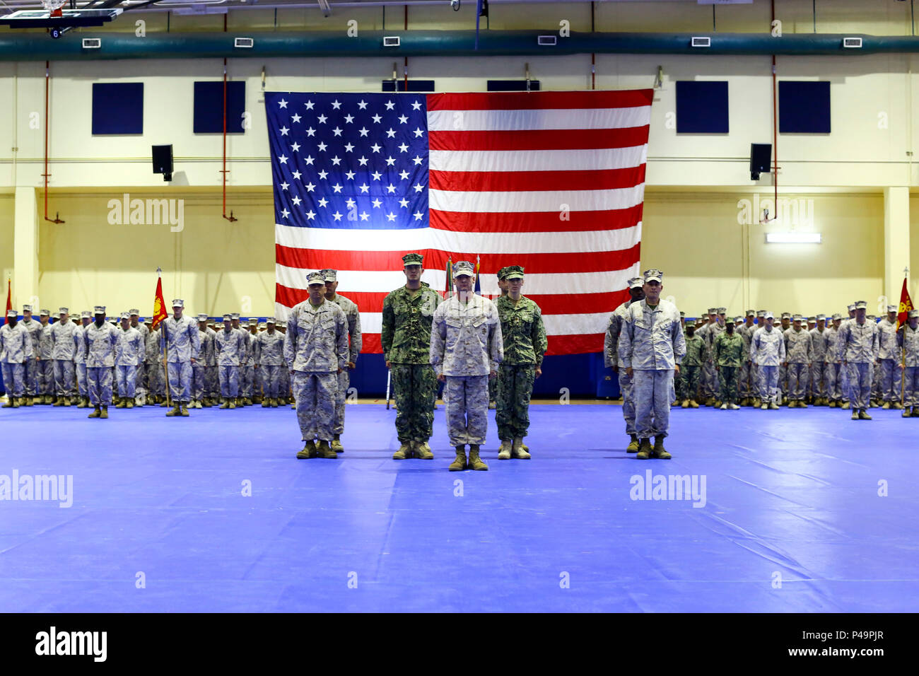 U.S. Marines and Sailors with 5th Marine Expeditionary Brigade stand in ...