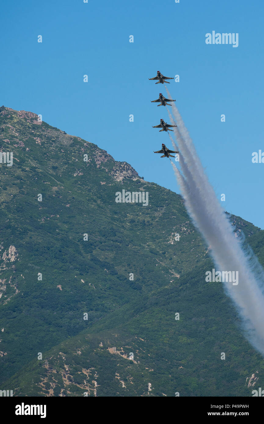 The Thunderbirds pilots perform the Trail to Diamond Loop maneuver ...