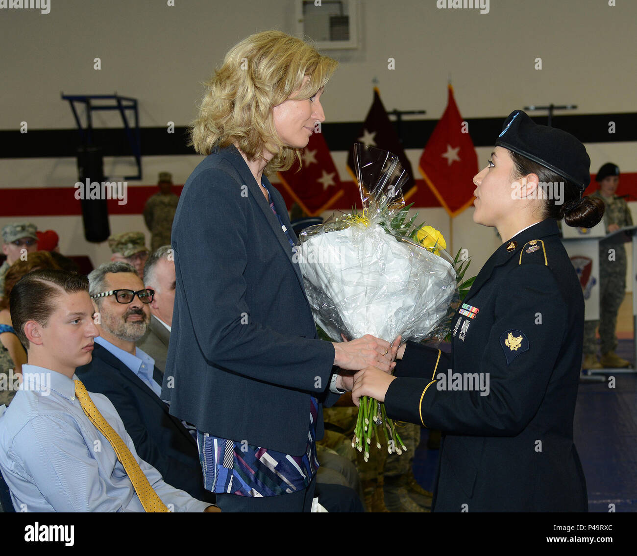 Mrs. Traudi Retzlaff, spouse of Col.(P) Dennis LeMaster, is presented a ...
