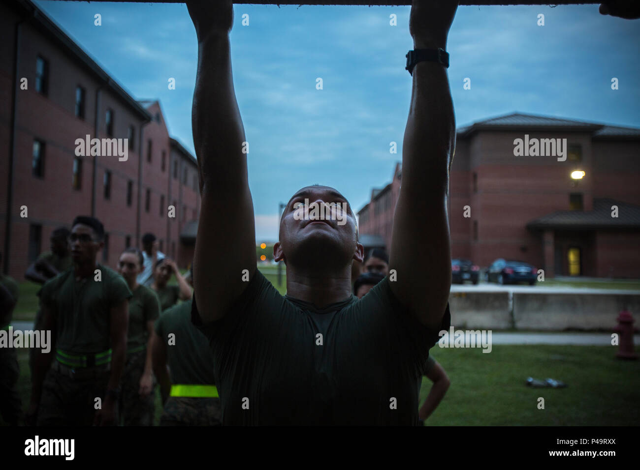 A U.S. Marine assigned to Ground Supply School, performs pull-ups ...