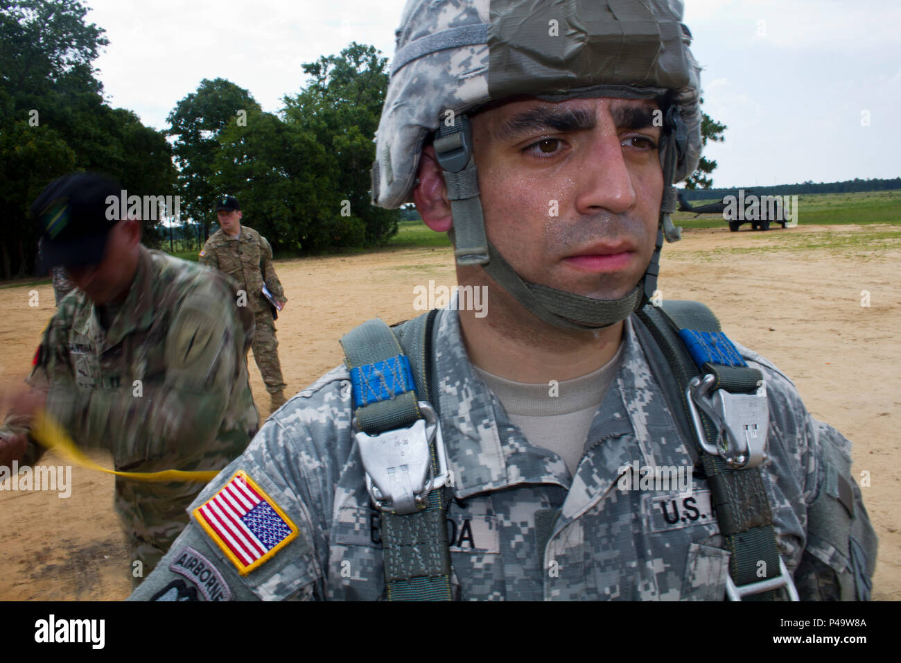 Sgt. Eric-James Estrada, 4th MISG(A), has his static line checked by ...