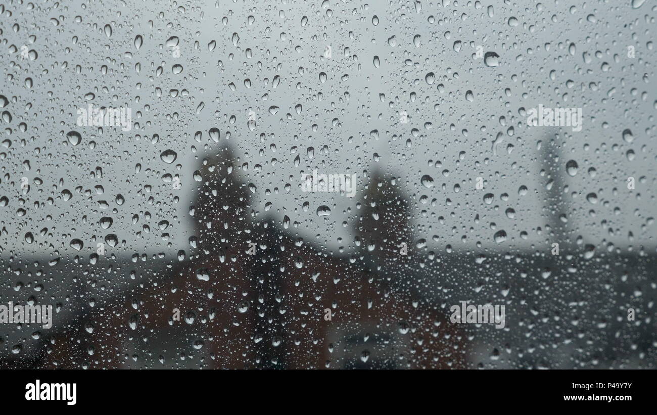 Large rain drops strike a window pane during heavy shower in England Stock Photo - Alamy