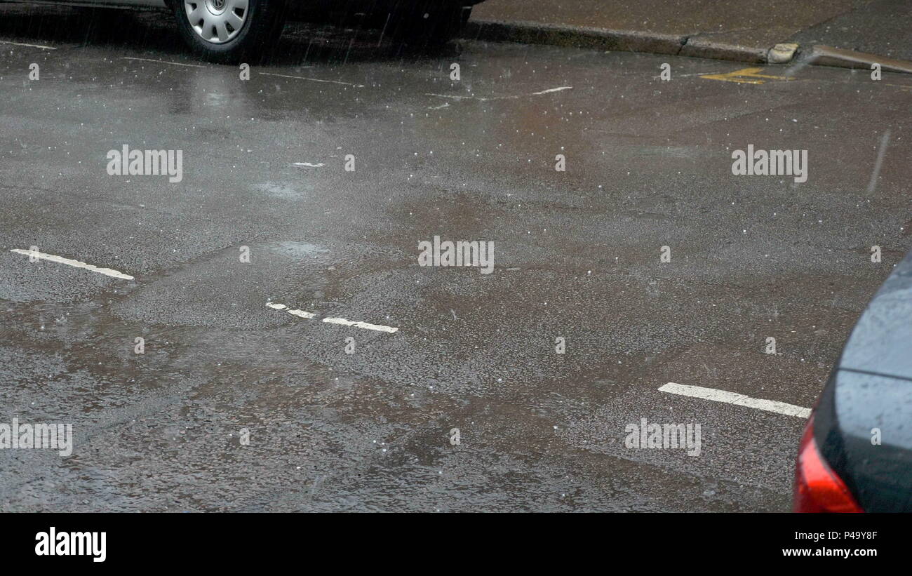 Large rain drops and hailstones strike parked cars during heavy shower in England Stock Photo ...
