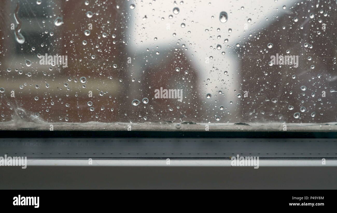Large rain drops strike open window pane during heavy shower in England Stock Photo - Alamy