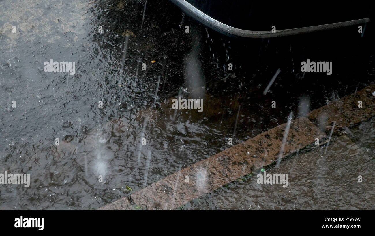 Large rain drops and hailstones strike parked cars during heavy shower in England Stock Photo ...