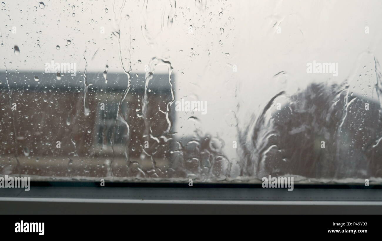 Large rain drops strike open window pane during heavy shower in England Stock Photo - Alamy