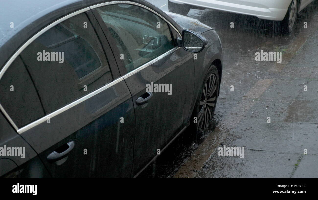 Large rain drops and hailstones strike parked cars during heavy shower in England Stock Photo ...
